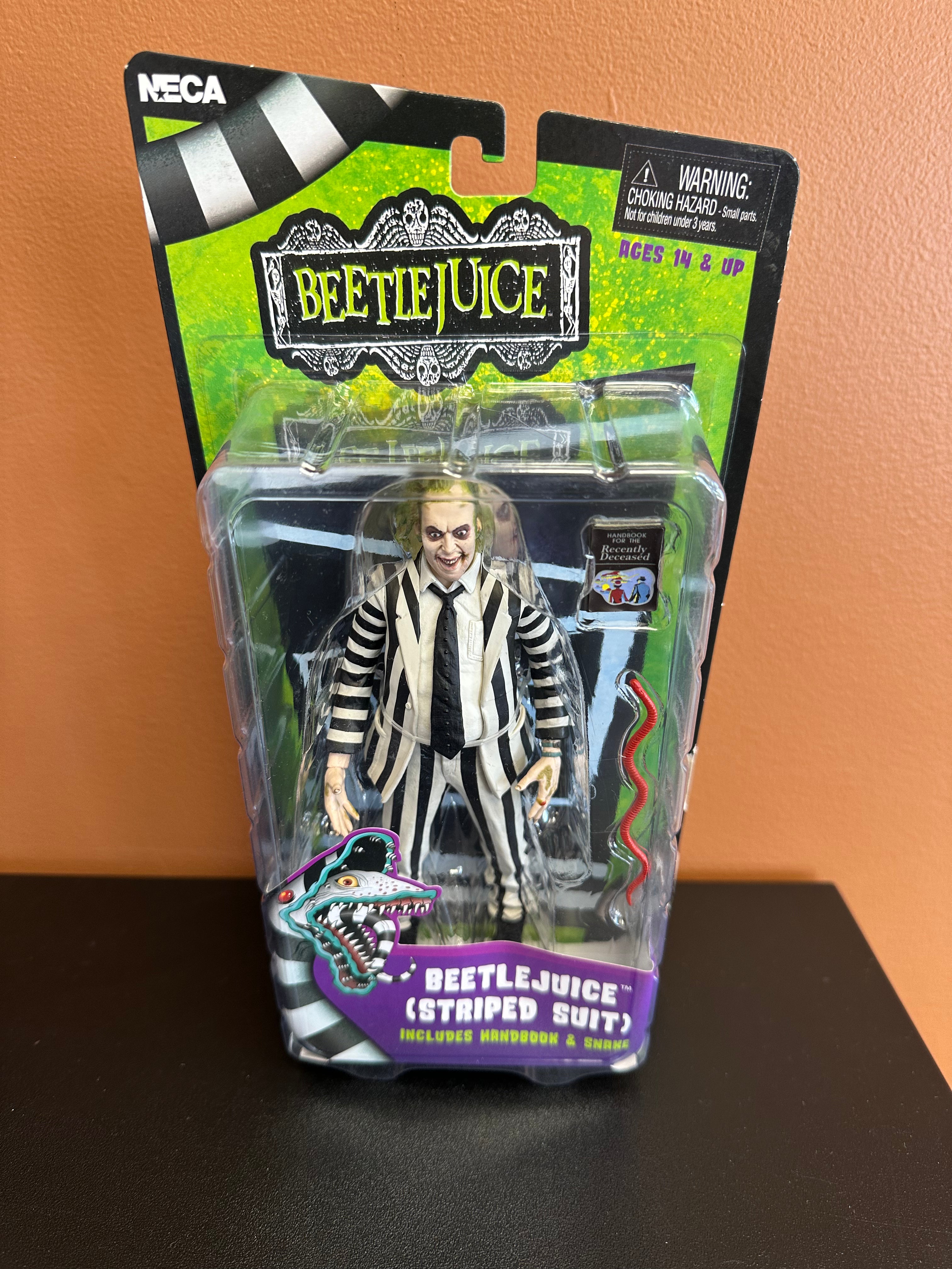 NECA BEETLEJUICE (1988) 7” SCALE FIGURE WITH BOOK & SNAKE – Hitchhiker Toys